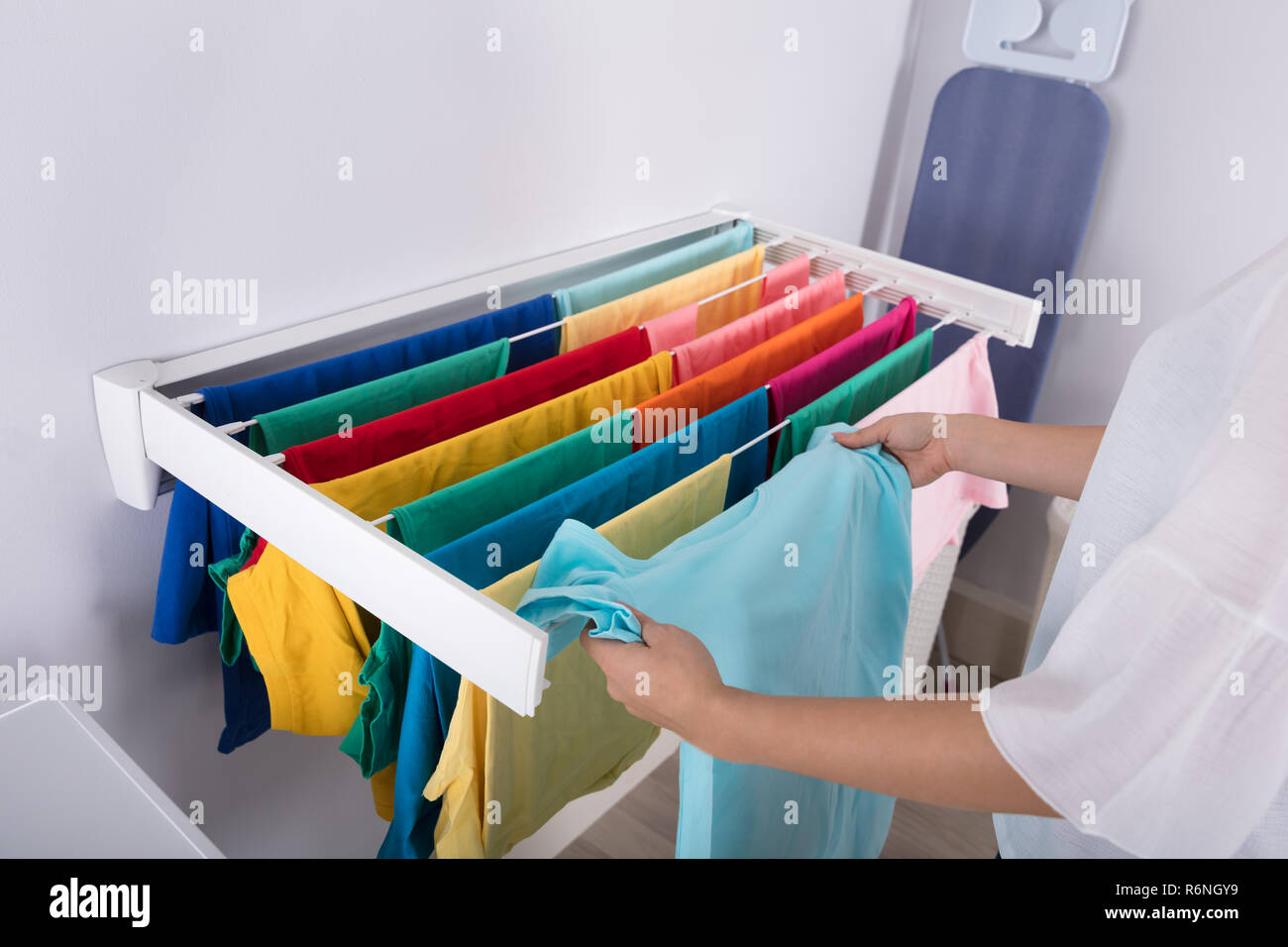 Woman Hanging Clothes On Clothes Line Stock Photo - Alamy