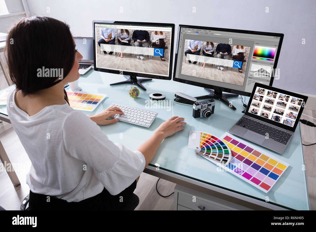 Female Designer Working On Multiple Computer Stock Photo - Alamy