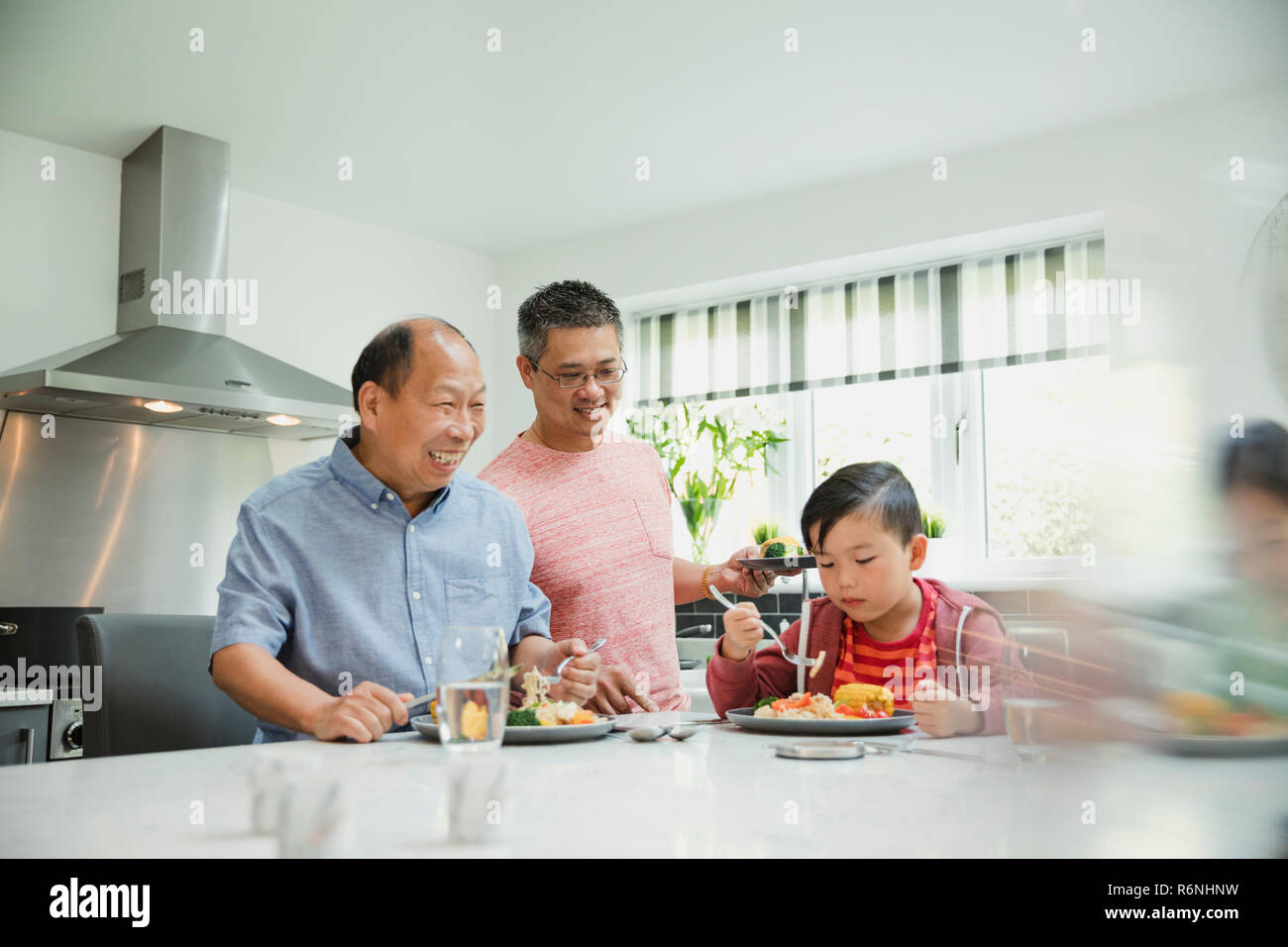 Family Enjoying a Stir Fry Together Stock Photo - Alamy