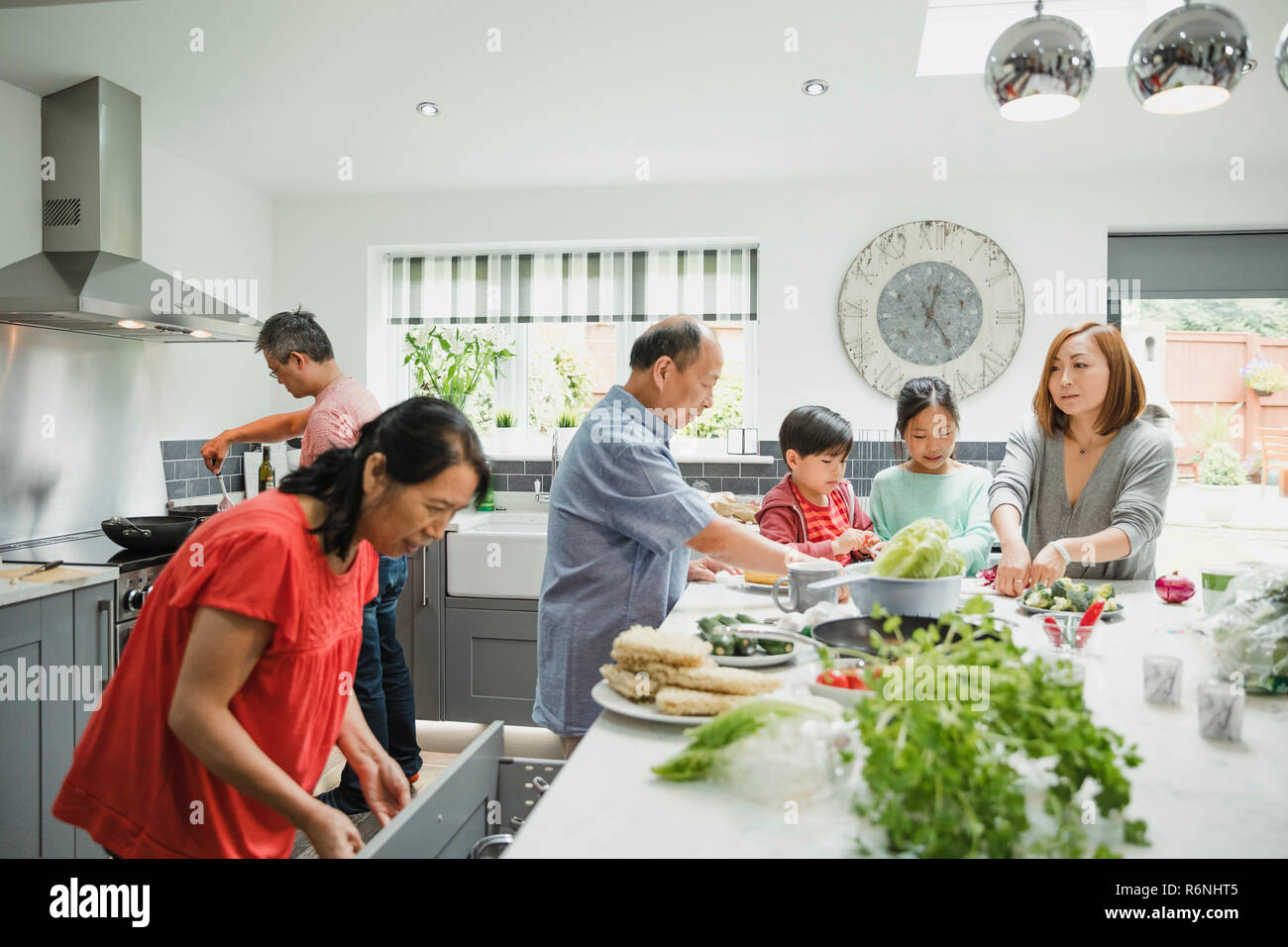 Family Preparing a Stir Fry Together Stock Photo - Alamy