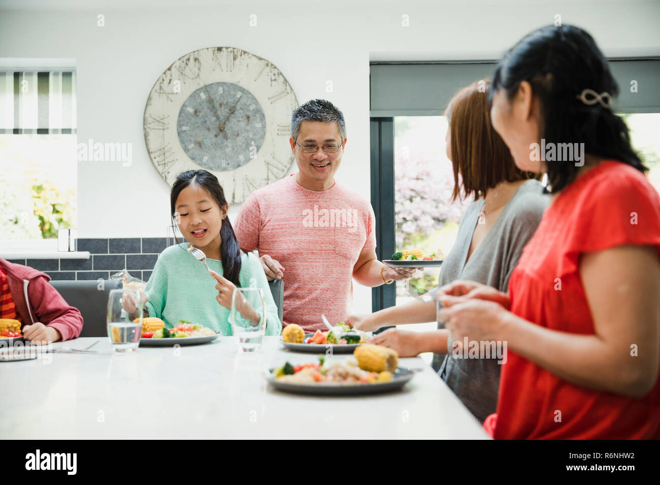 Three Generation Family Having Dinner Stock Photo - Alamy