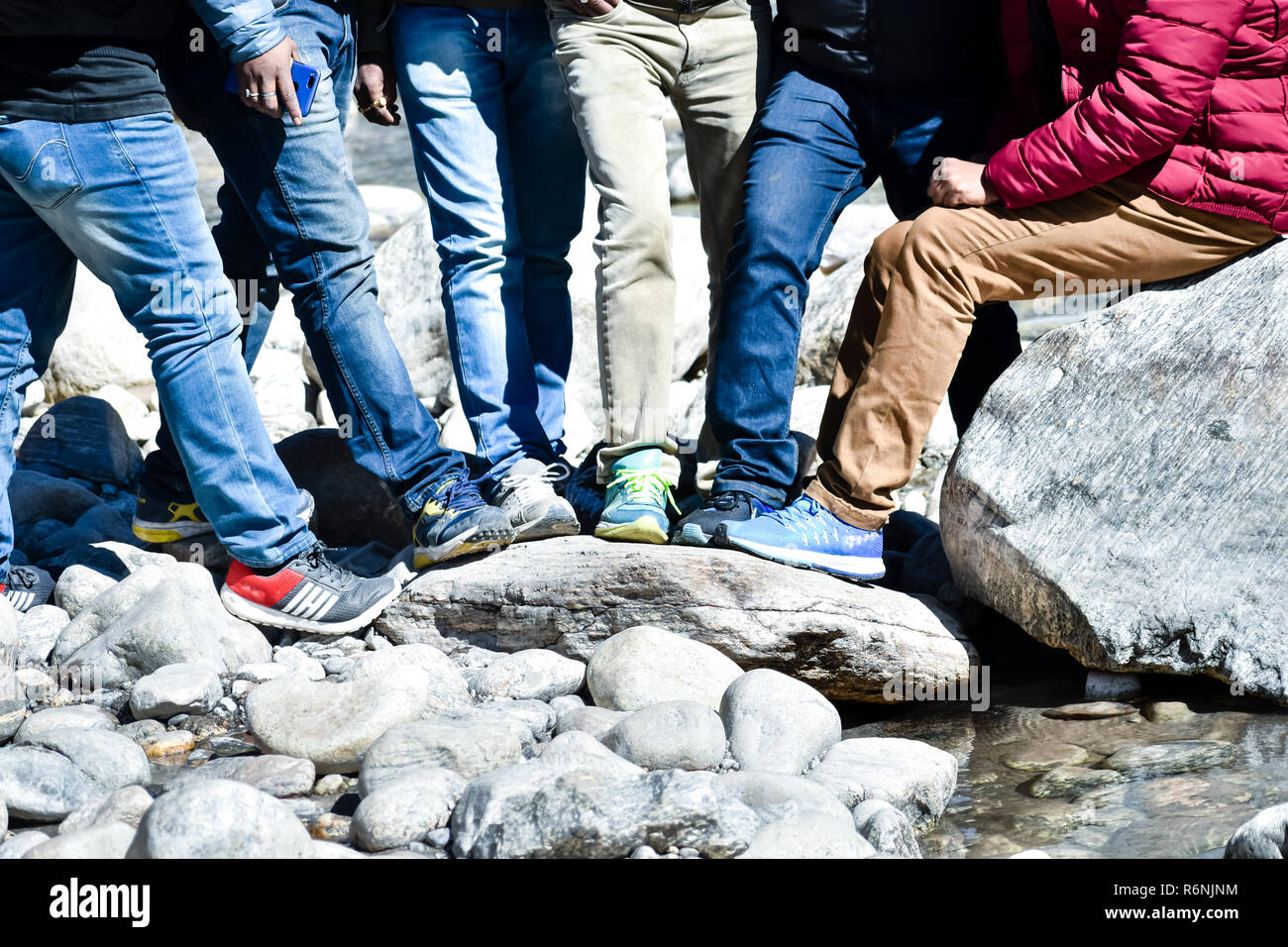 People putting legs together , close-up. Young group of friends on ...