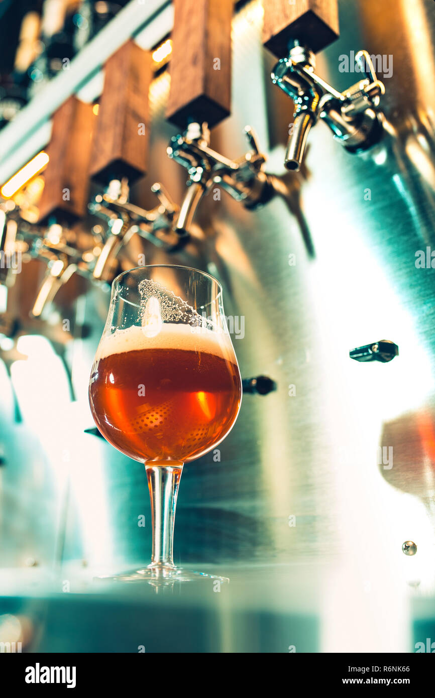 Beer craft. Bar table. Steel taps. Shiny taps. Glass of beer Stock ...