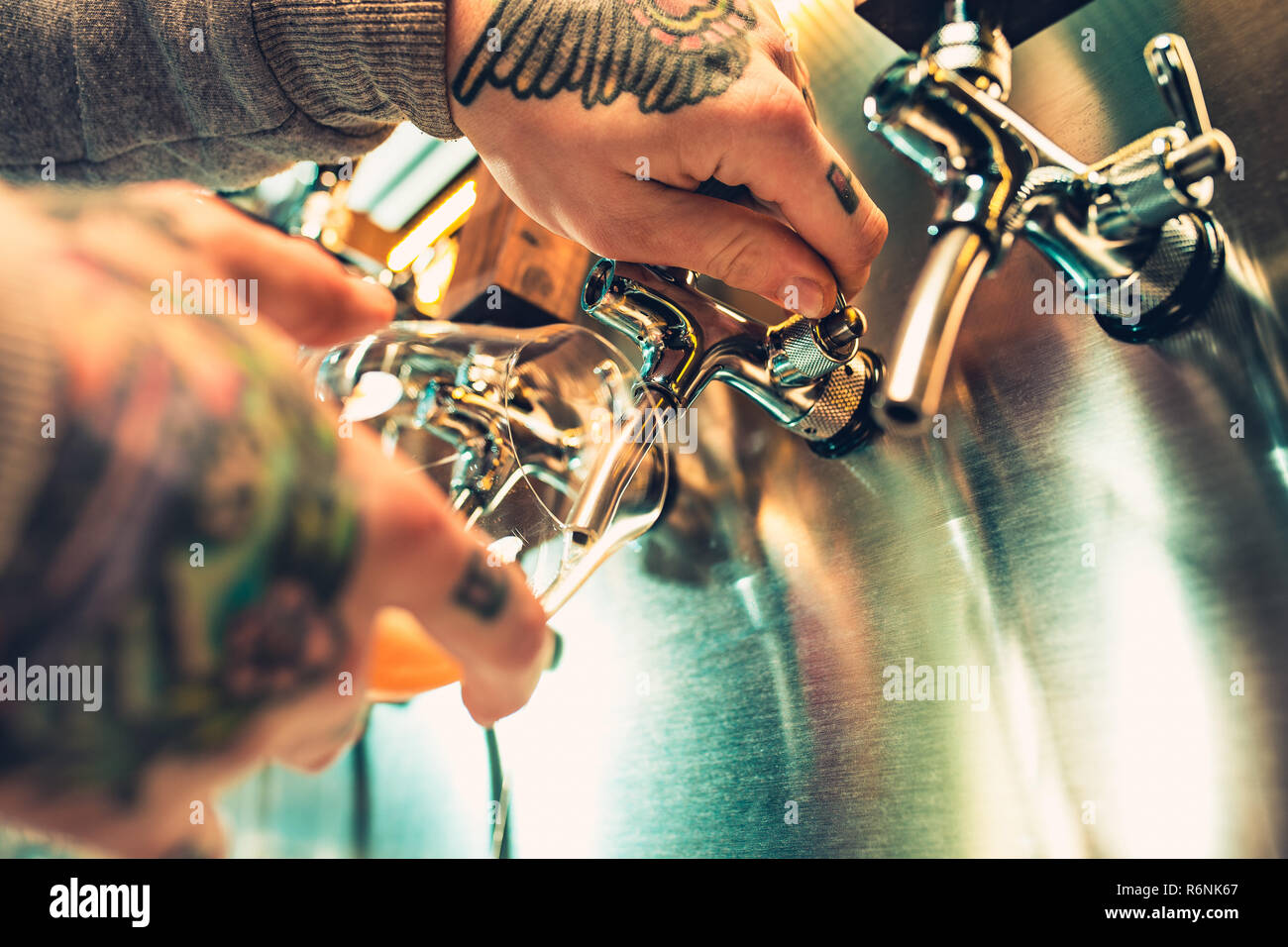 Hand of bartender pouring a large lager beer in tap Stock Photo - Alamy