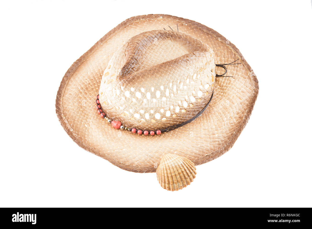 ladies straw hat decorated with little seashell on white background ...