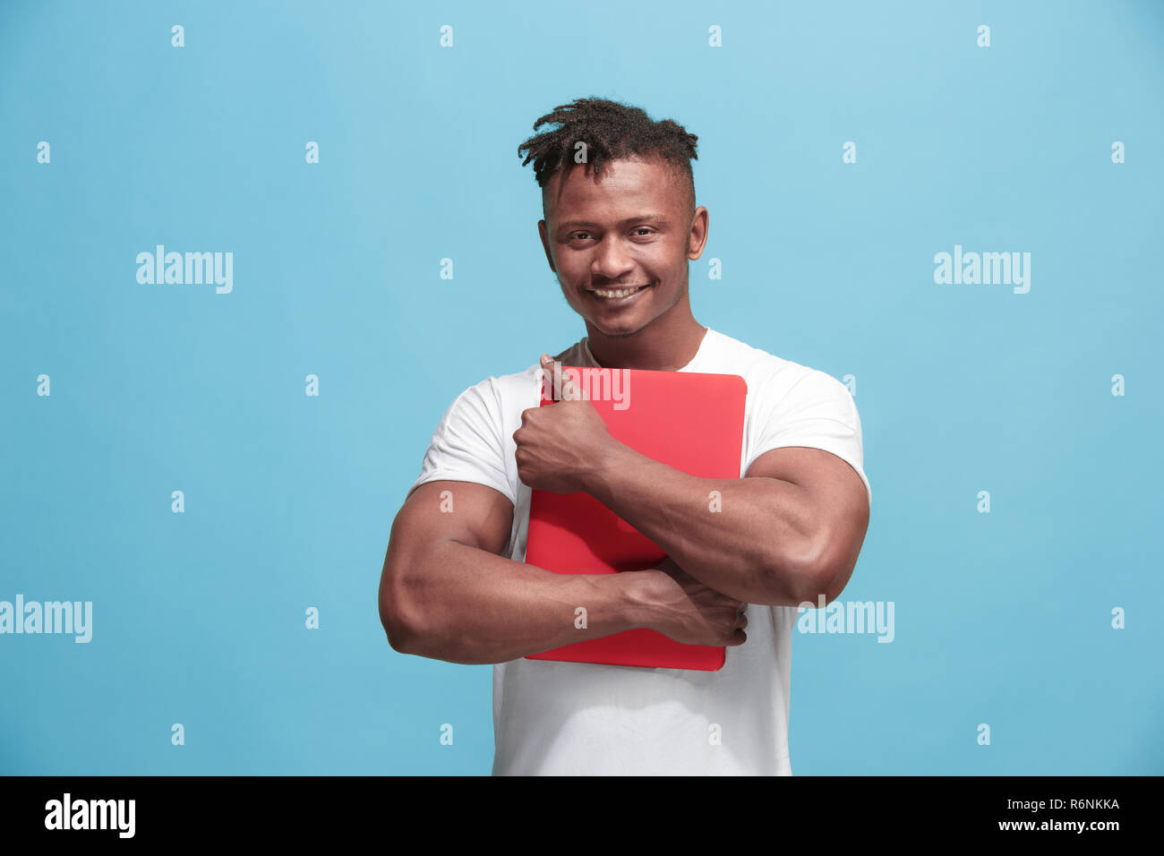 Afro-American Businessman hugging laptop Stock Photo - Alamy