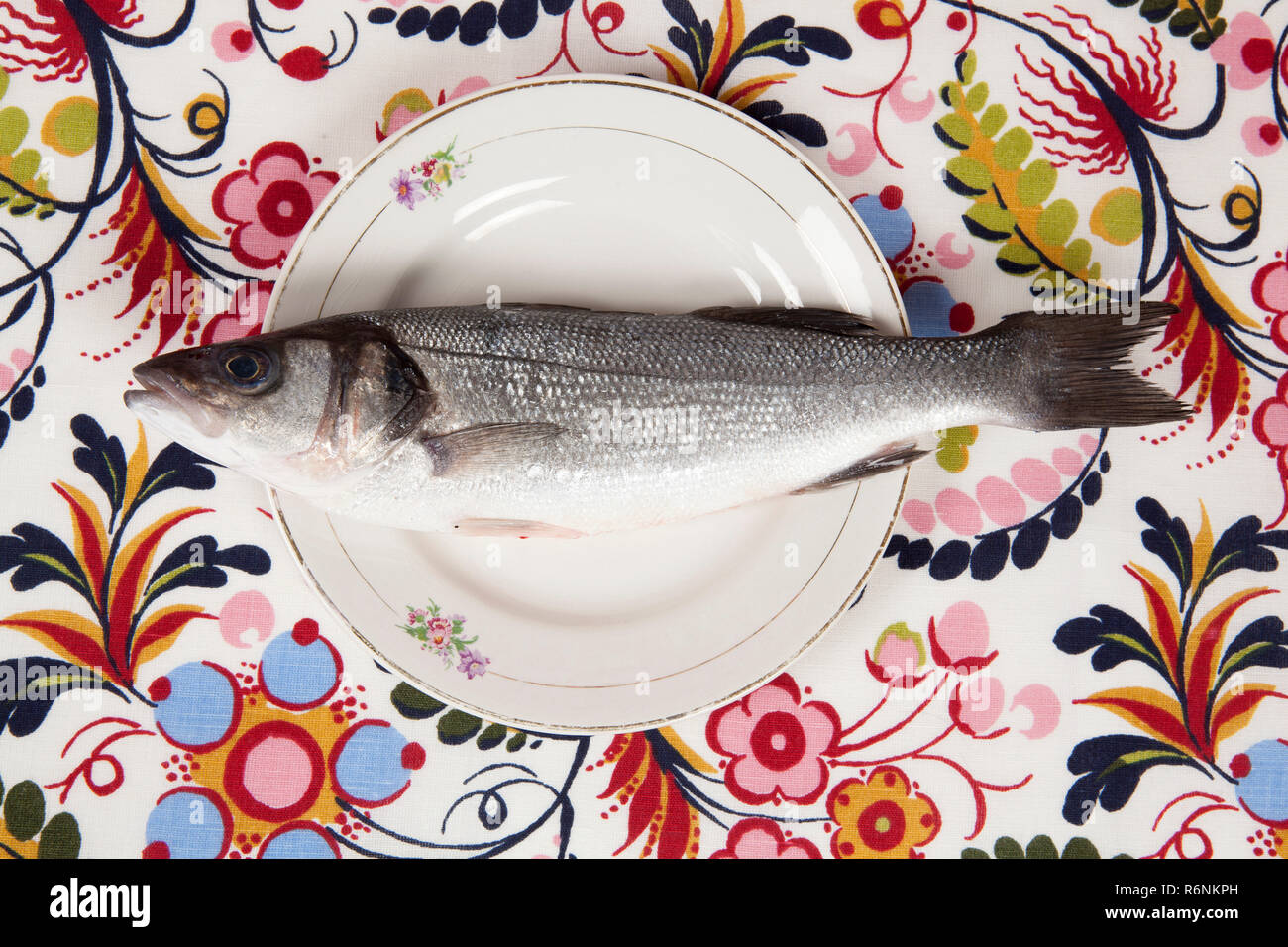 bass fish inside a flower plate Stock Photo - Alamy