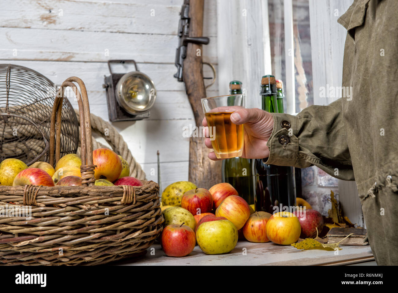 man drinking glass of cider, bottle and organic apples Stock Photo - Alamy