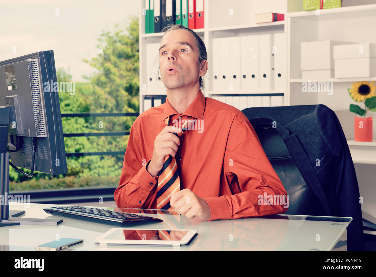 young business man with ventilator at his desk in summerly hot o Stock ...