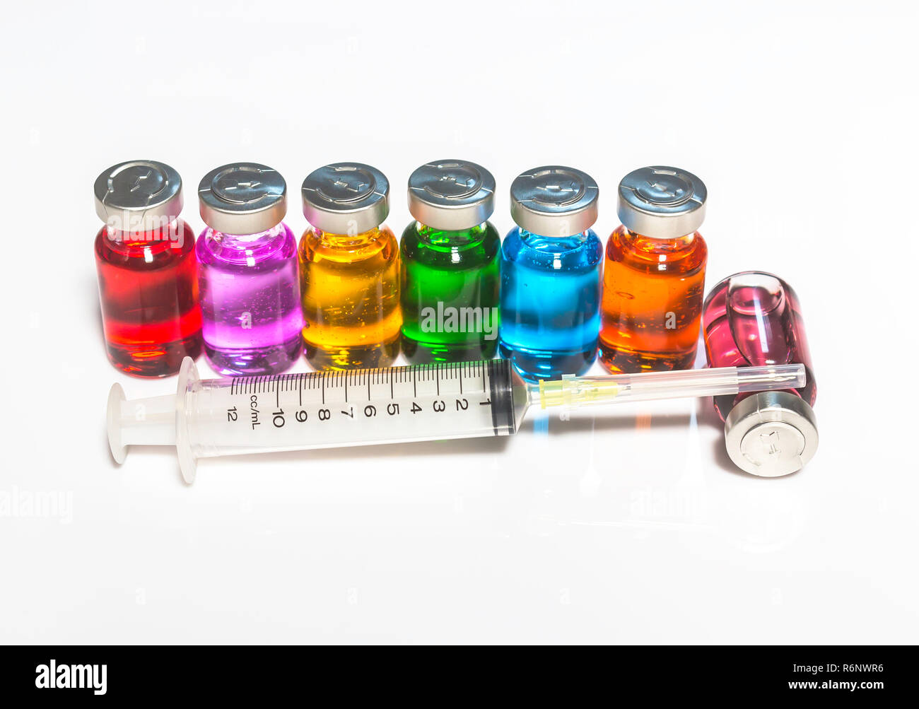 Injection needle syringe and vials with medicine on white Stock Photo ...