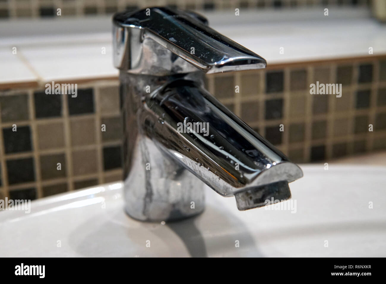 Interior of bathroom with sink basin faucet. Open chrome faucet ...