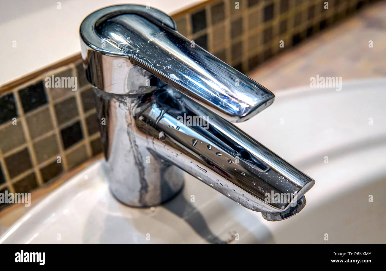 Interior of bathroom with sink basin faucet. Open chrome faucet ...