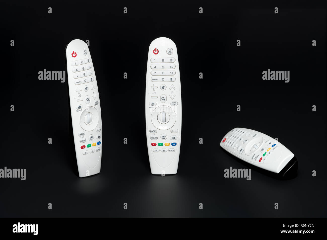 Three stylish white remotes, isolated on black background Stock Photo ...