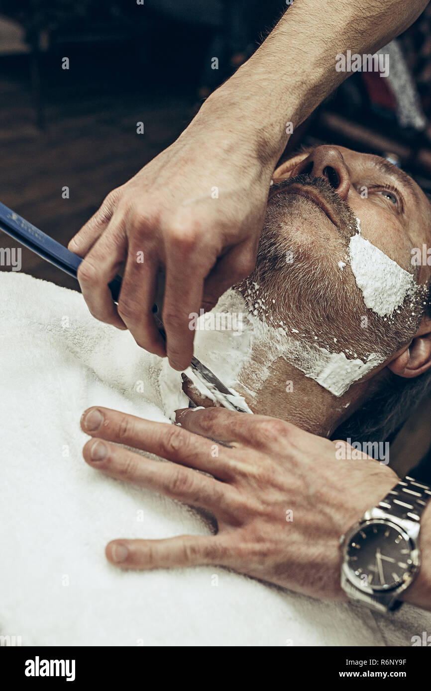 Close-up side top view handsome senior bearded caucasian man getting ...