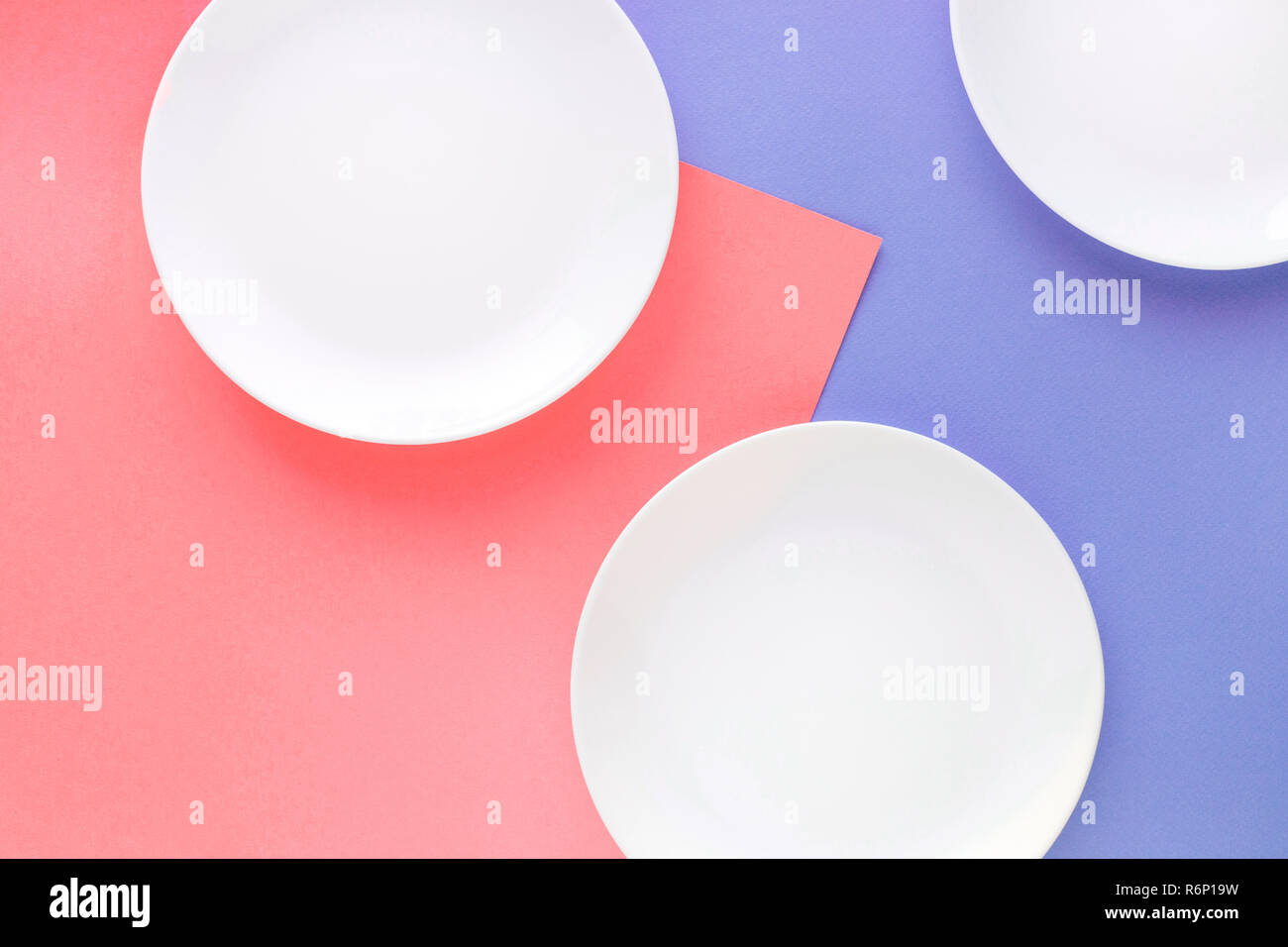 Three white plates on color background. Abstract, top view. Living ...