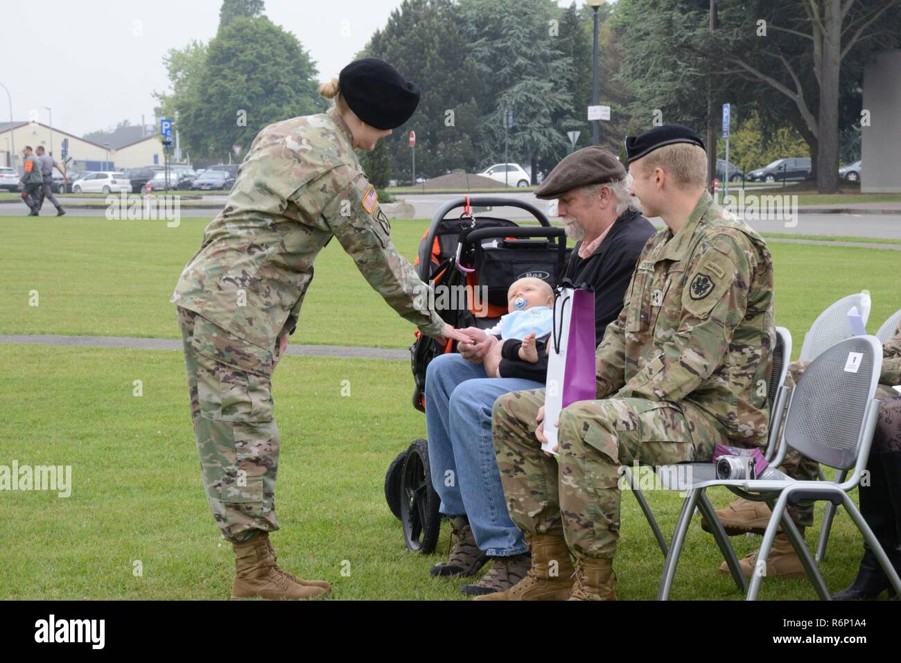 U.S. Army Cpt. Danielle K. Cork's father and son, receive a unit coin ...