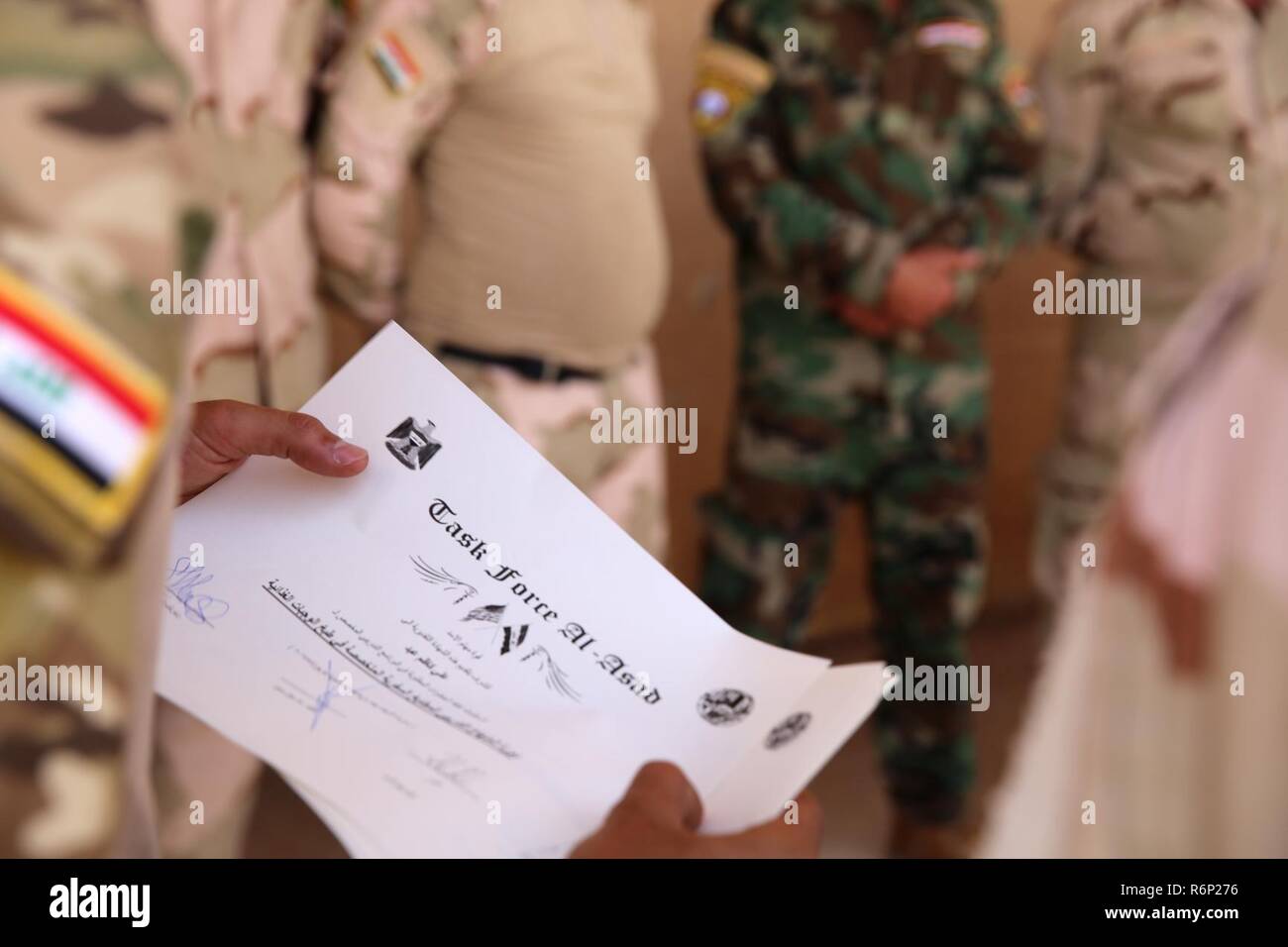 An Iraqi soldier with the 7th Iraqi Army Division holds a certificate ...