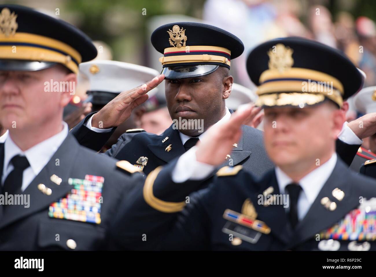 Service members from across the armed forces salute the colors ...