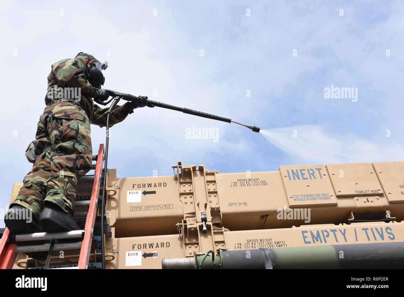 A member of U.S. Army 1-1 Air Defense Artillery decontaminates an MIM ...