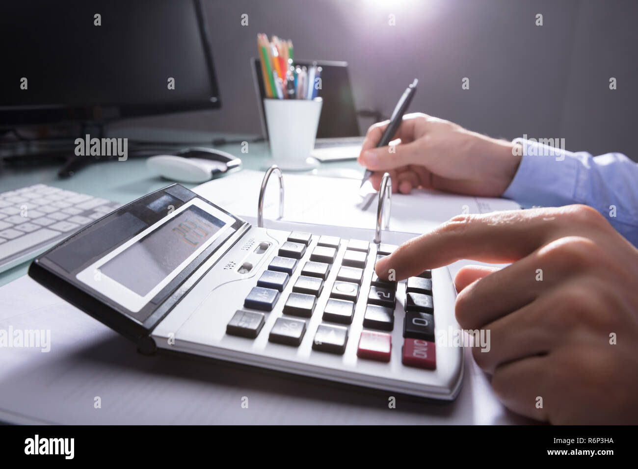 Businessperson Calculating Receipt With Calculator Stock Photo - Alamy