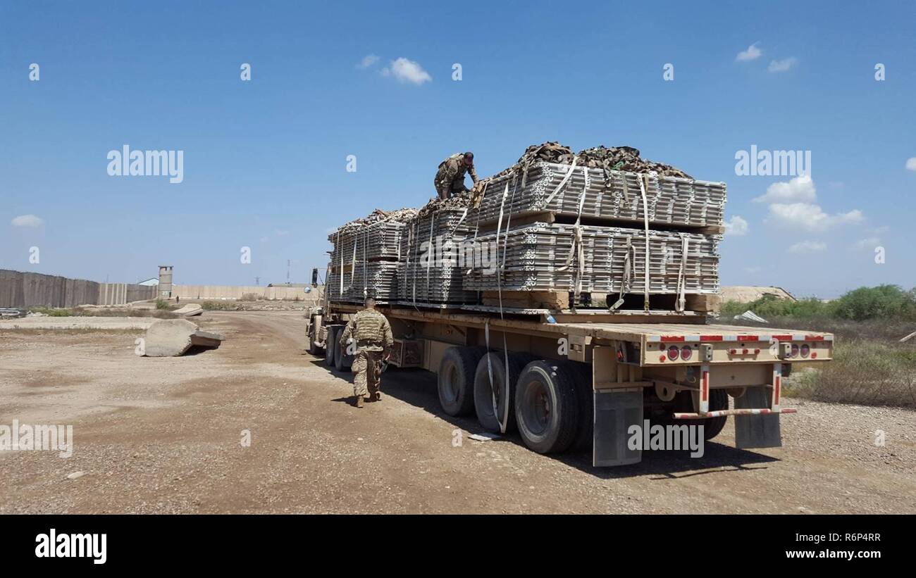 Members of the U.S. Army 574th Combat Support Command secure a load of ...