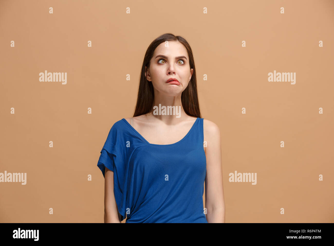 The woman with weird expression isolated on pastel Stock Photo - Alamy