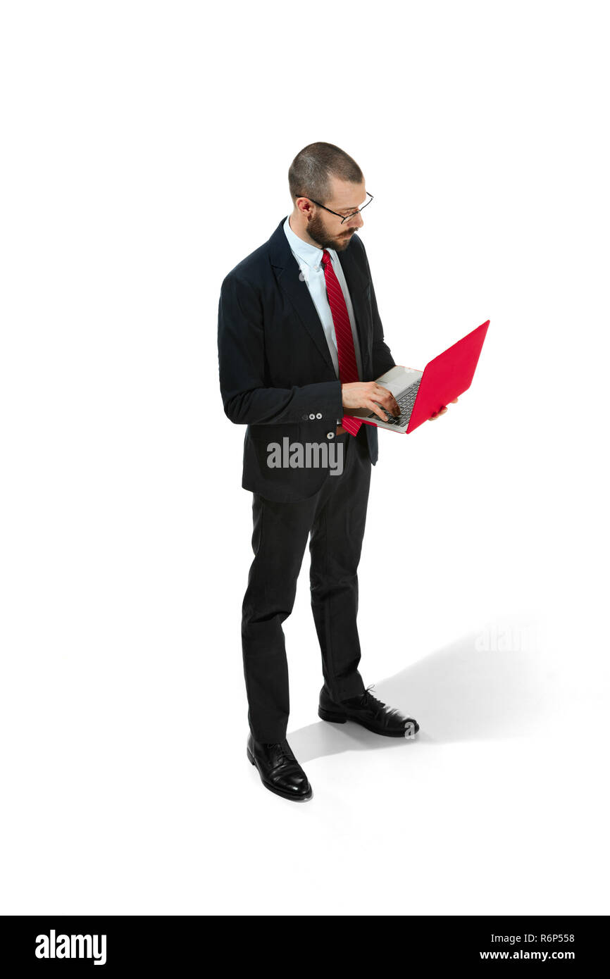 Picture of handsome young bearded man standing over white studio ...