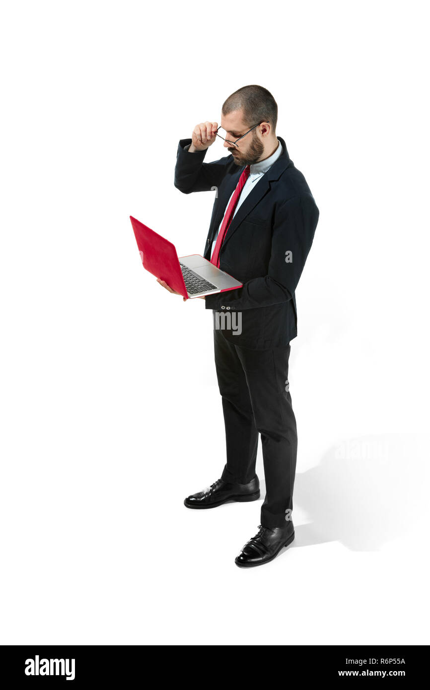 Picture of handsome young bearded man standing over white studio ...