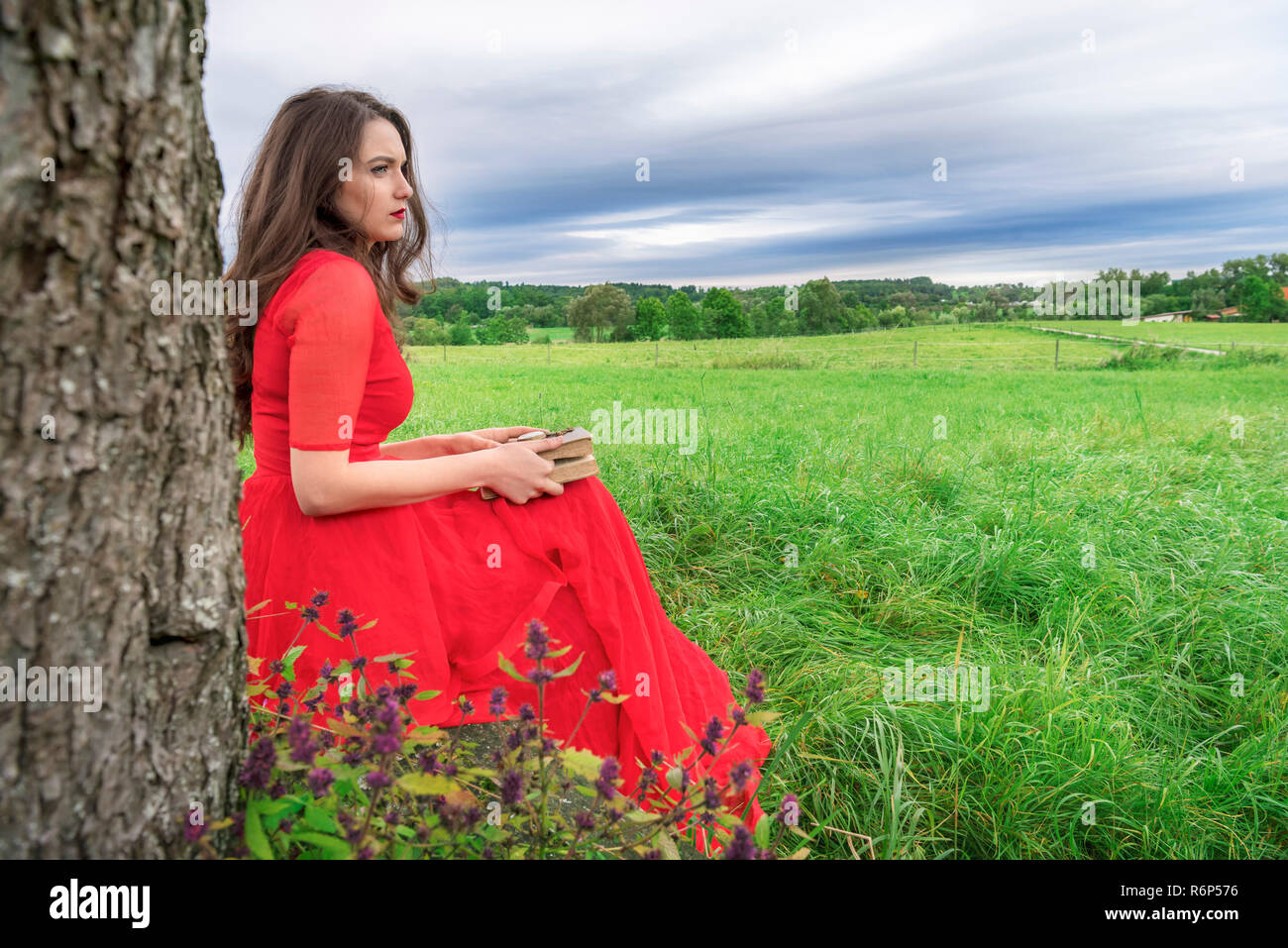 Woman meditating under tree hi-res stock photography and images - Alamy