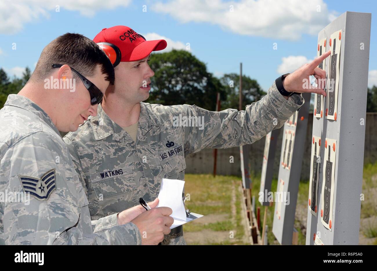 Staff Sgt. Daniel Watkins (right), 627th Security Forces Squadron combat arms instructor, shows ...