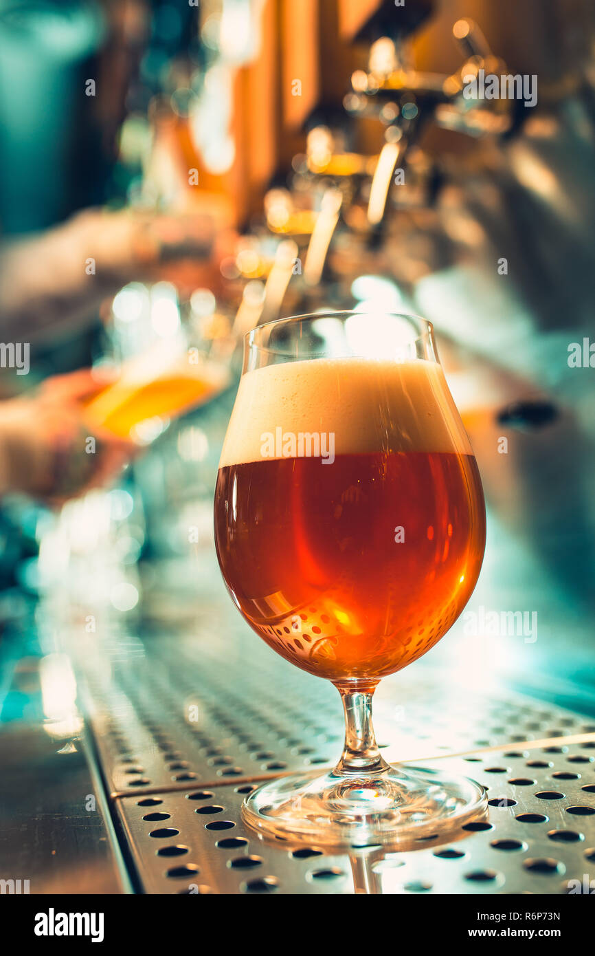 Hand of bartender pouring a large lager beer in tap Stock Photo - Alamy