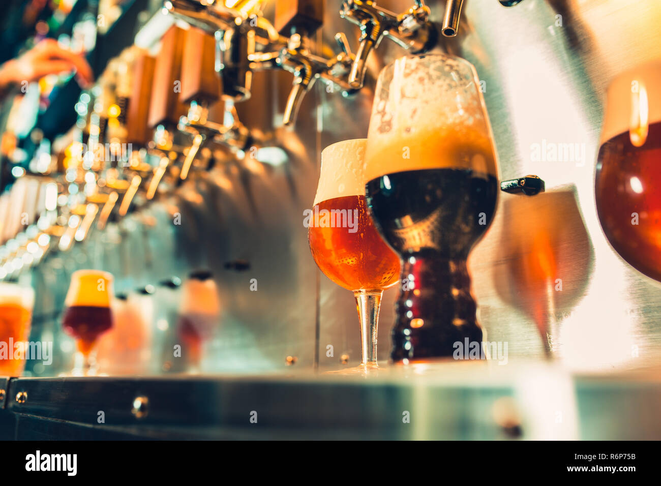 Hand of bartender pouring a large lager beer in tap Stock Photo - Alamy