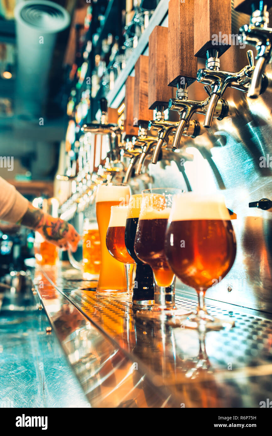 Hand of bartender pouring a large lager beer in tap Stock Photo - Alamy