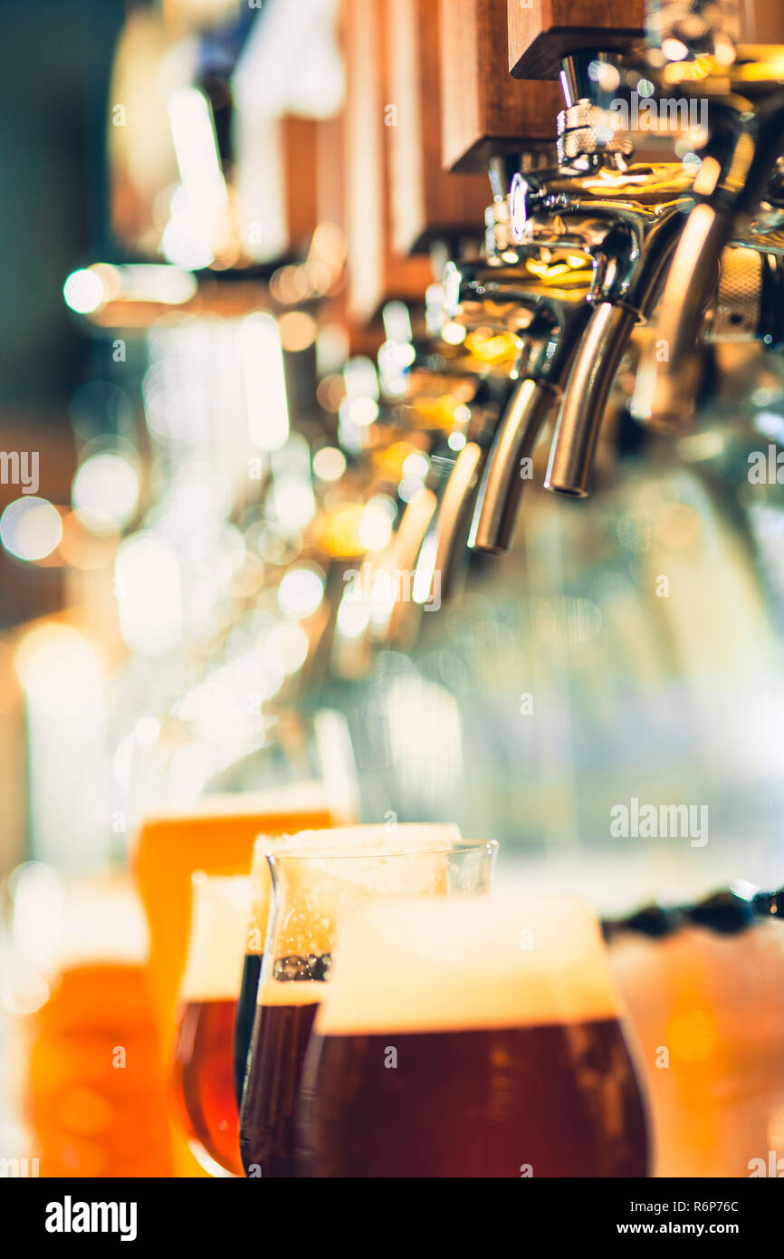 Beer craft. Bar table. Steel taps. Shiny taps. Glassses with beer Stock ...