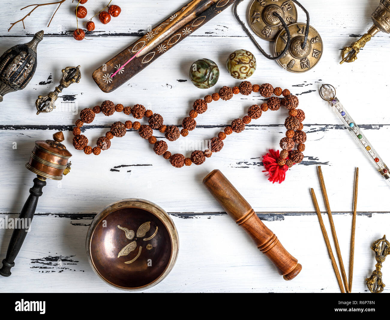 Copper singing bowl, prayer beads, prayer drum, stone balls Stock Photo ...