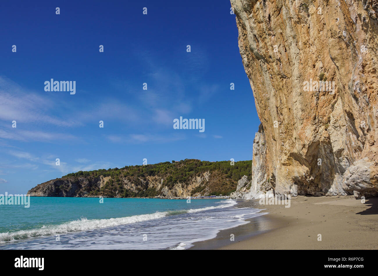 rocky wall on the beach in italy Stock Photo - Alamy