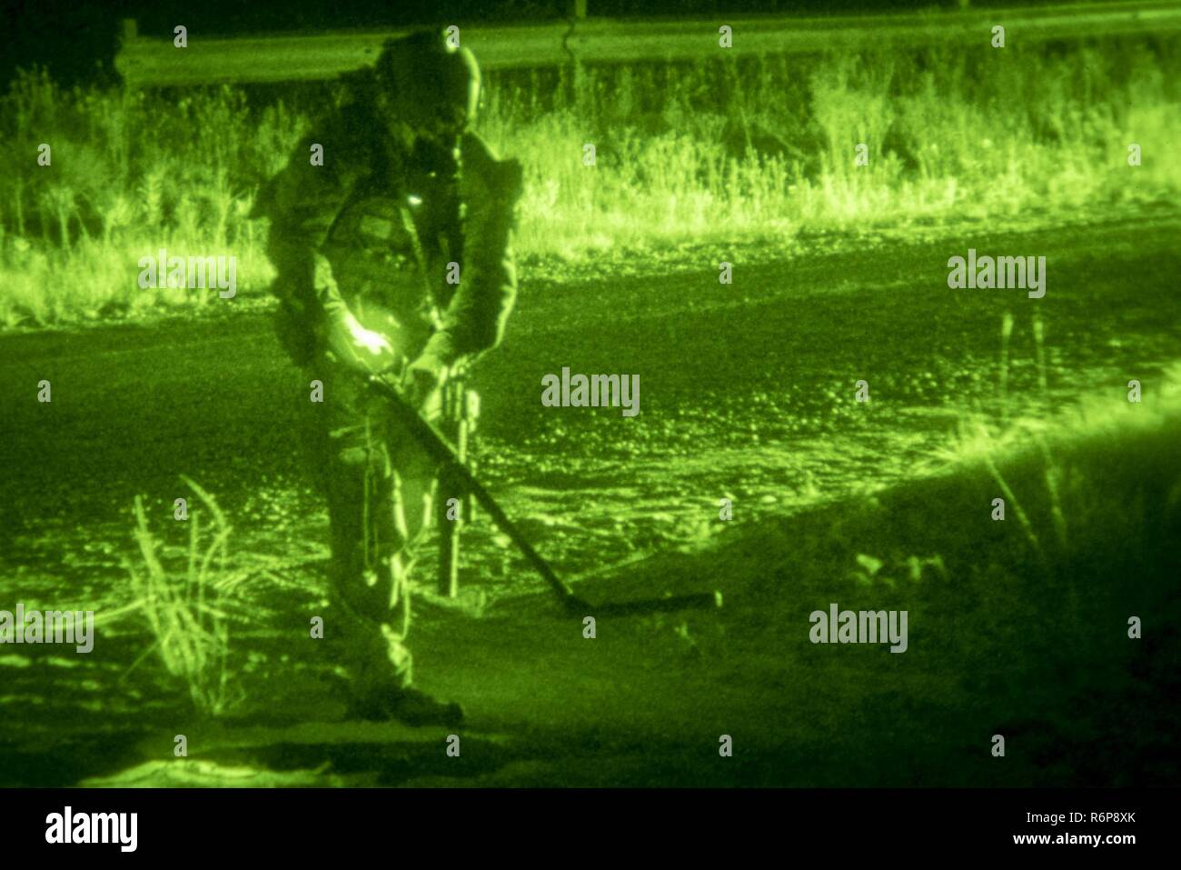 East coast members of Naval Special Warfare uses a metal detector to ...