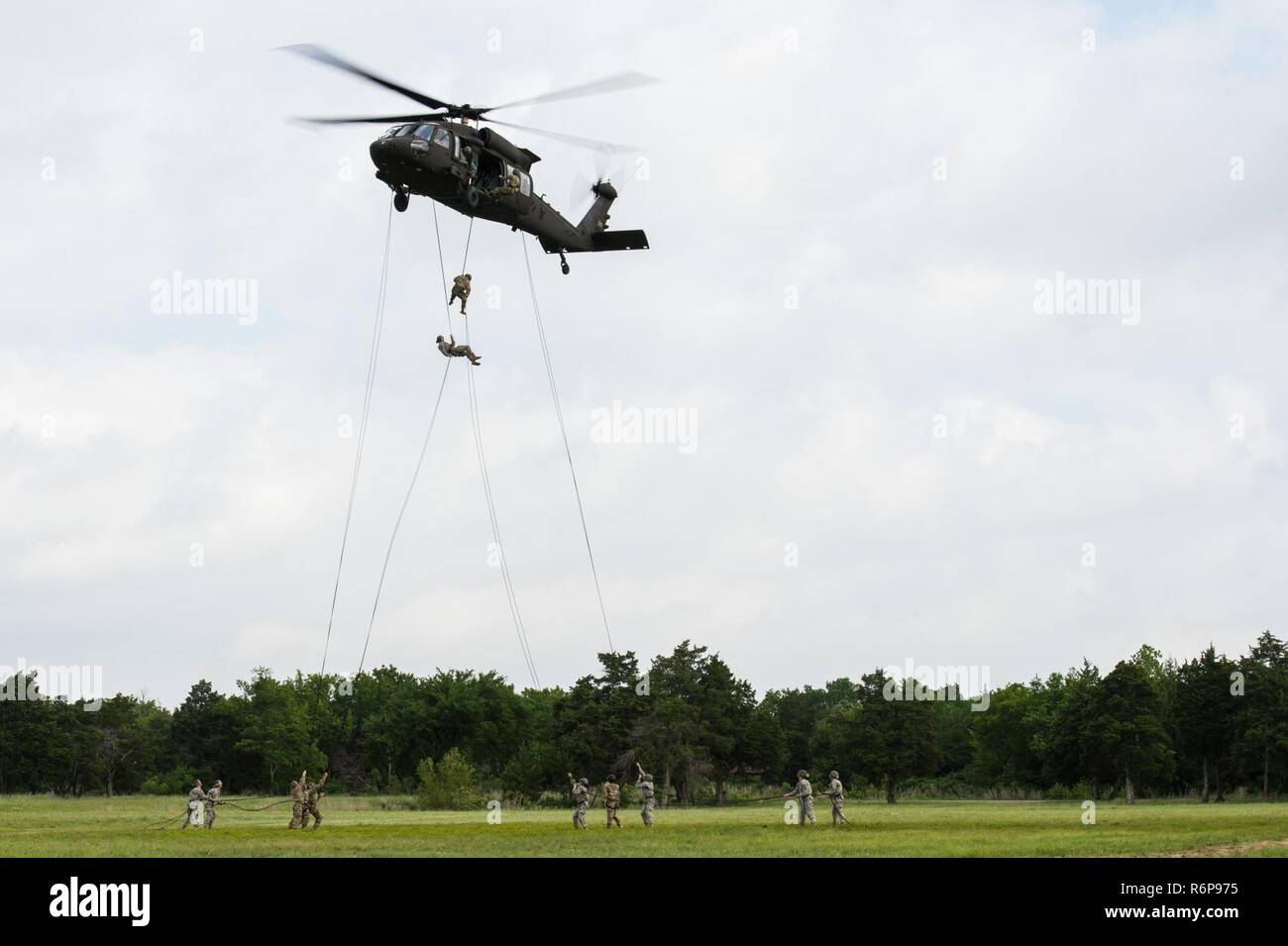 U.S. Army and Air National Guardsmen repel 70-90 feet from a UH-60 ...