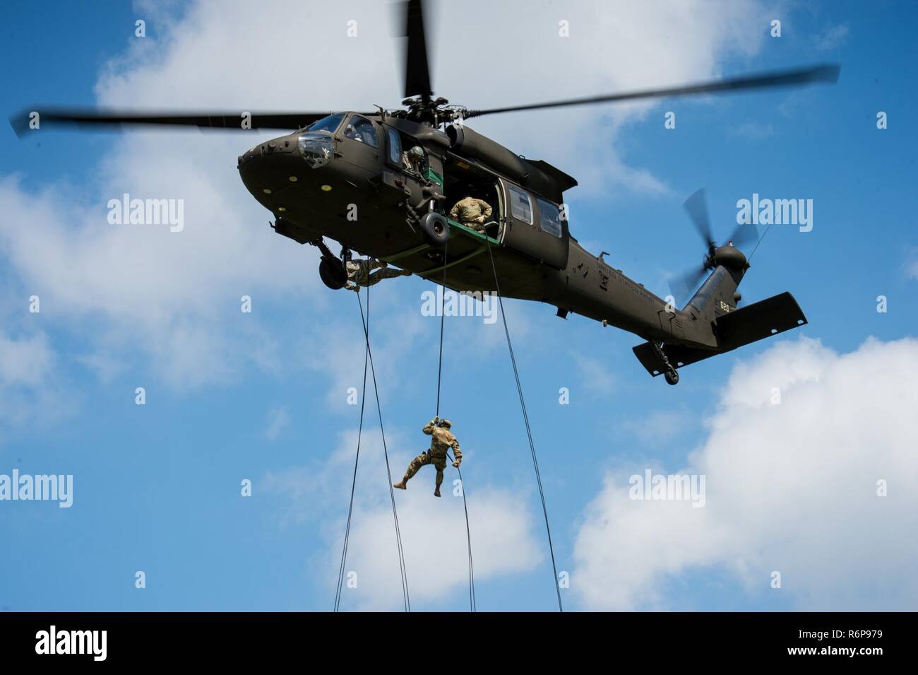 U.S. Army and Air National Guardsmen run repelling exercises during Air ...