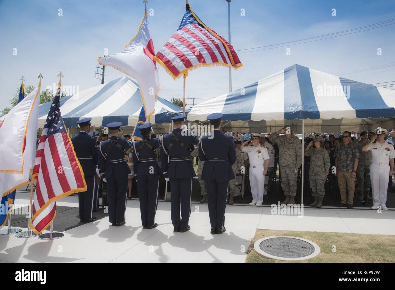 Base Honor Guard members hoist the colors for the singing of the ...
