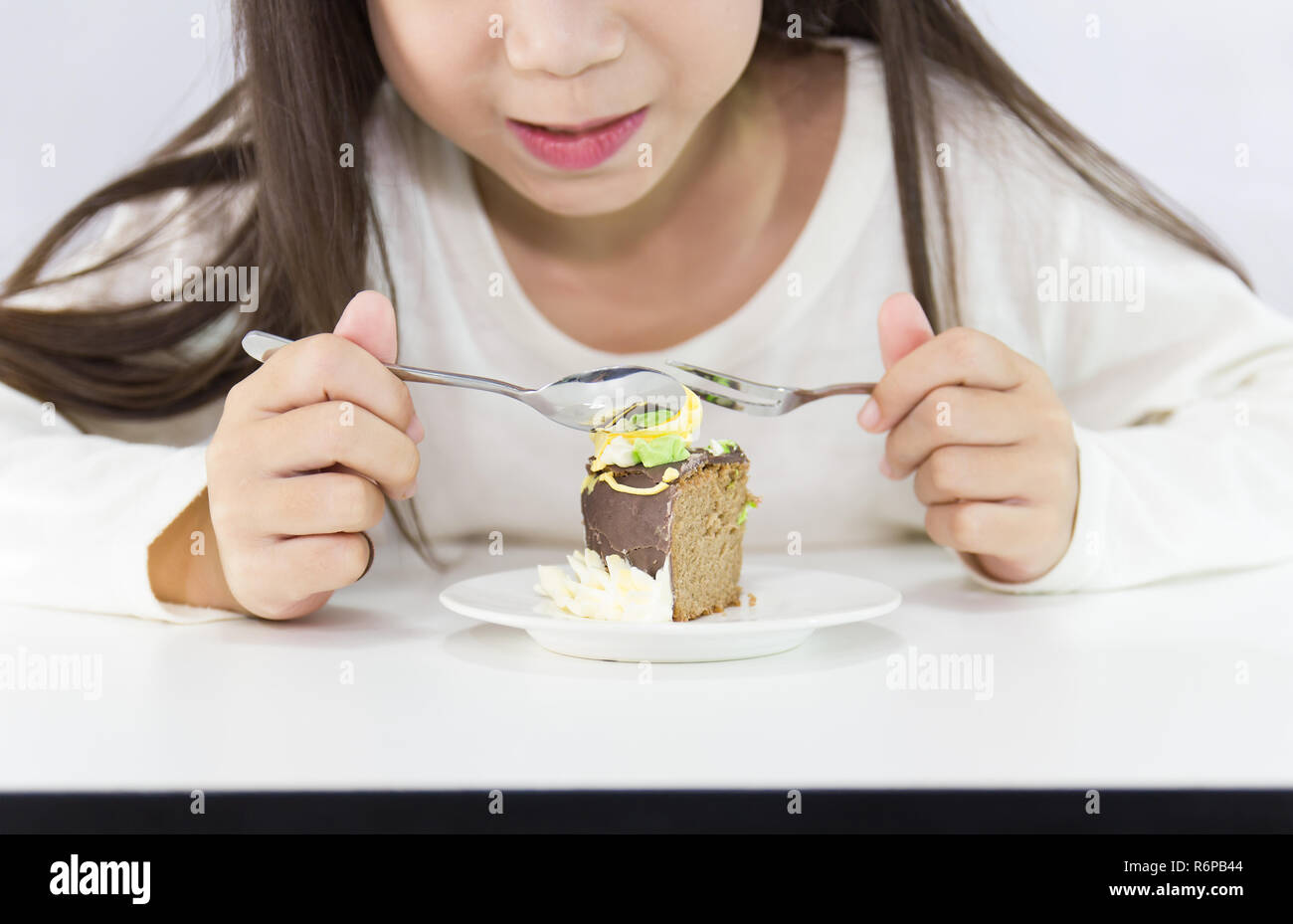Girl eating cake Stock Photo - Alamy