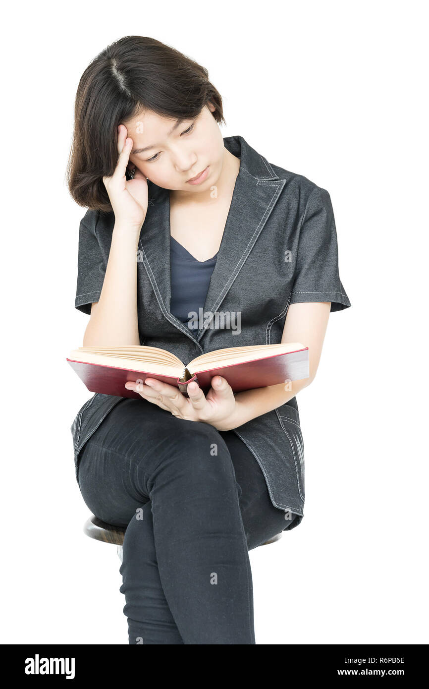 Woman reading a book sitting on chair Stock Photo - Alamy