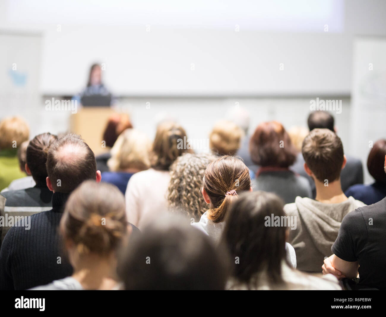 Woman giving presentation in lecture hall at university Stock Photo - Alamy