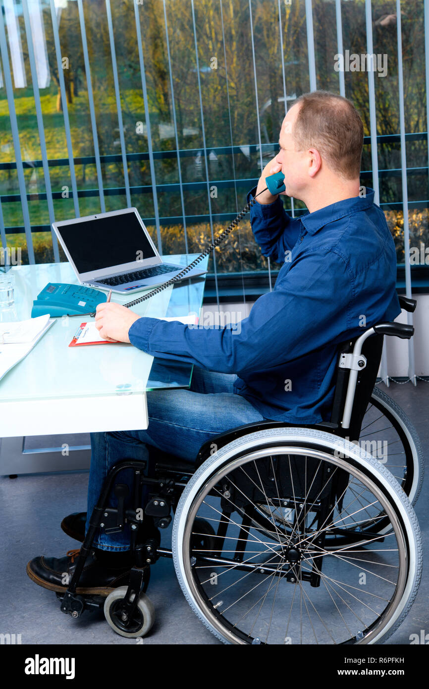 disabled business in wheelchair Stock Photo - Alamy