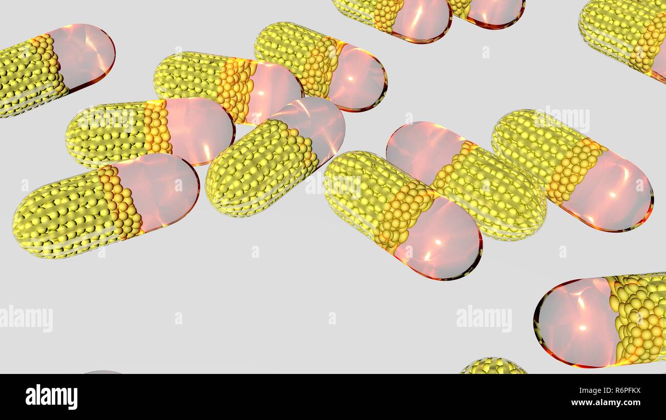 Close up view of shining capsule pills with small medicinal granules ...