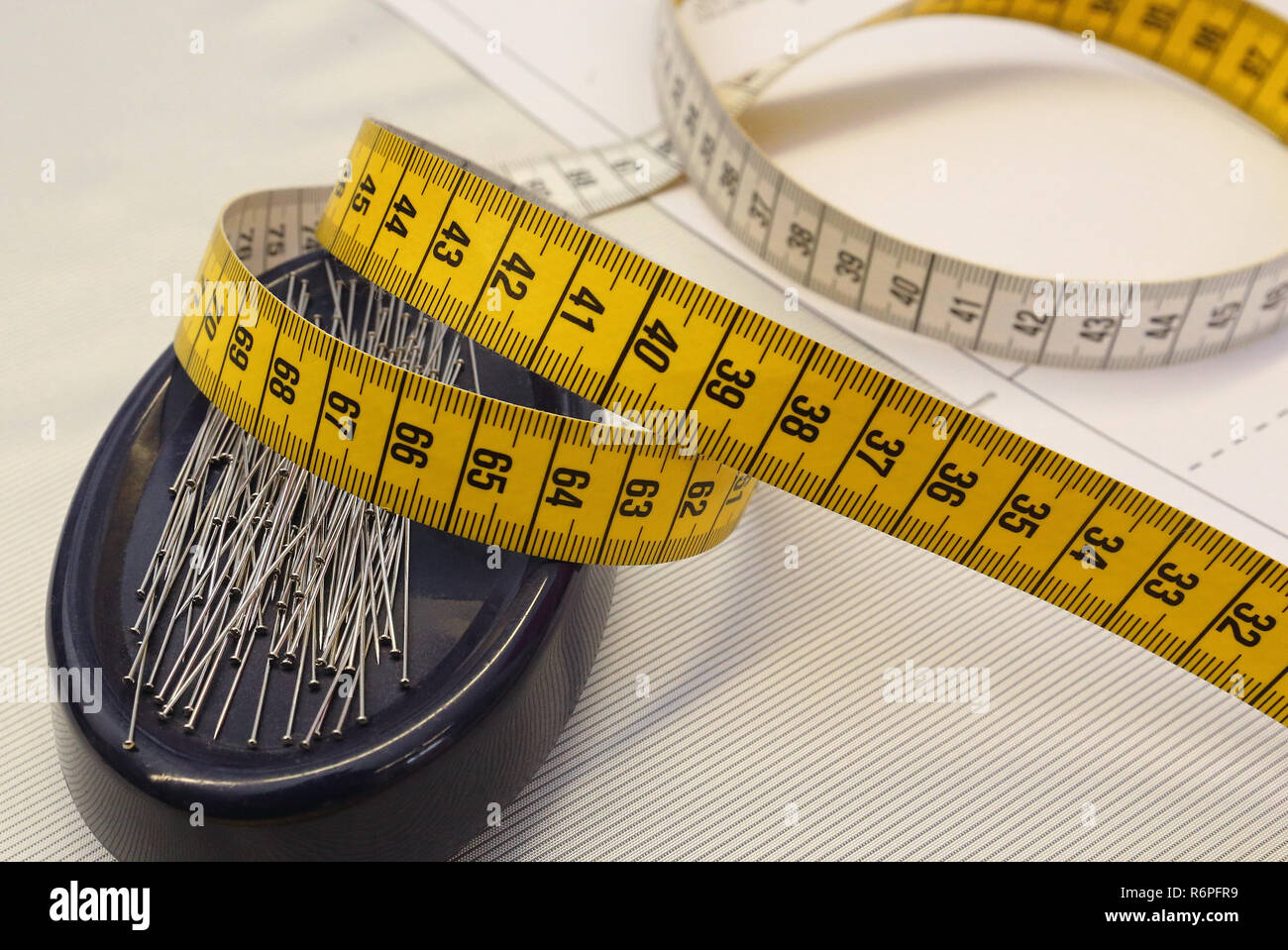 needles and tape measure Stock Photo - Alamy