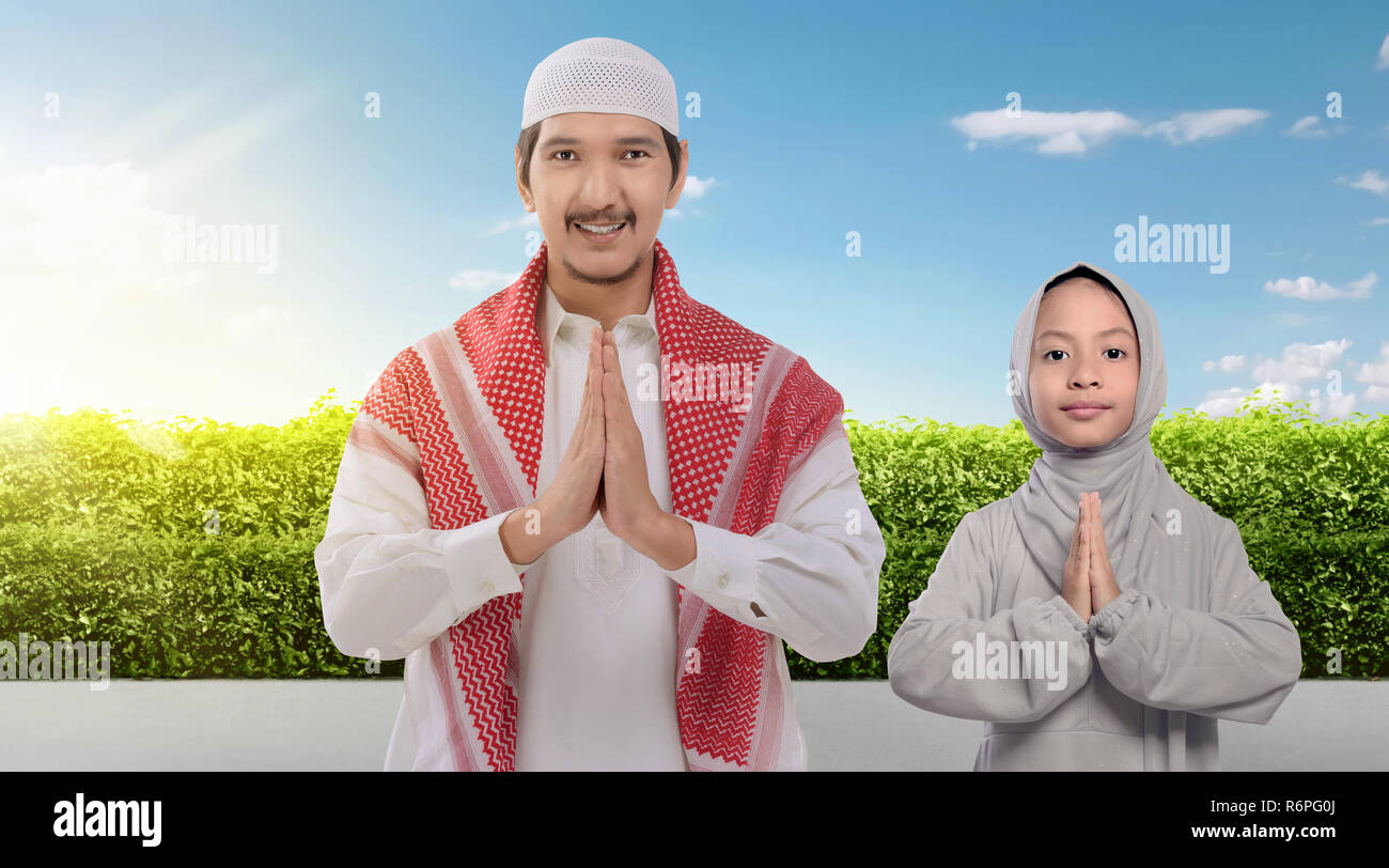 Smiling asian muslim father and daughter praying together Stock Photo ...