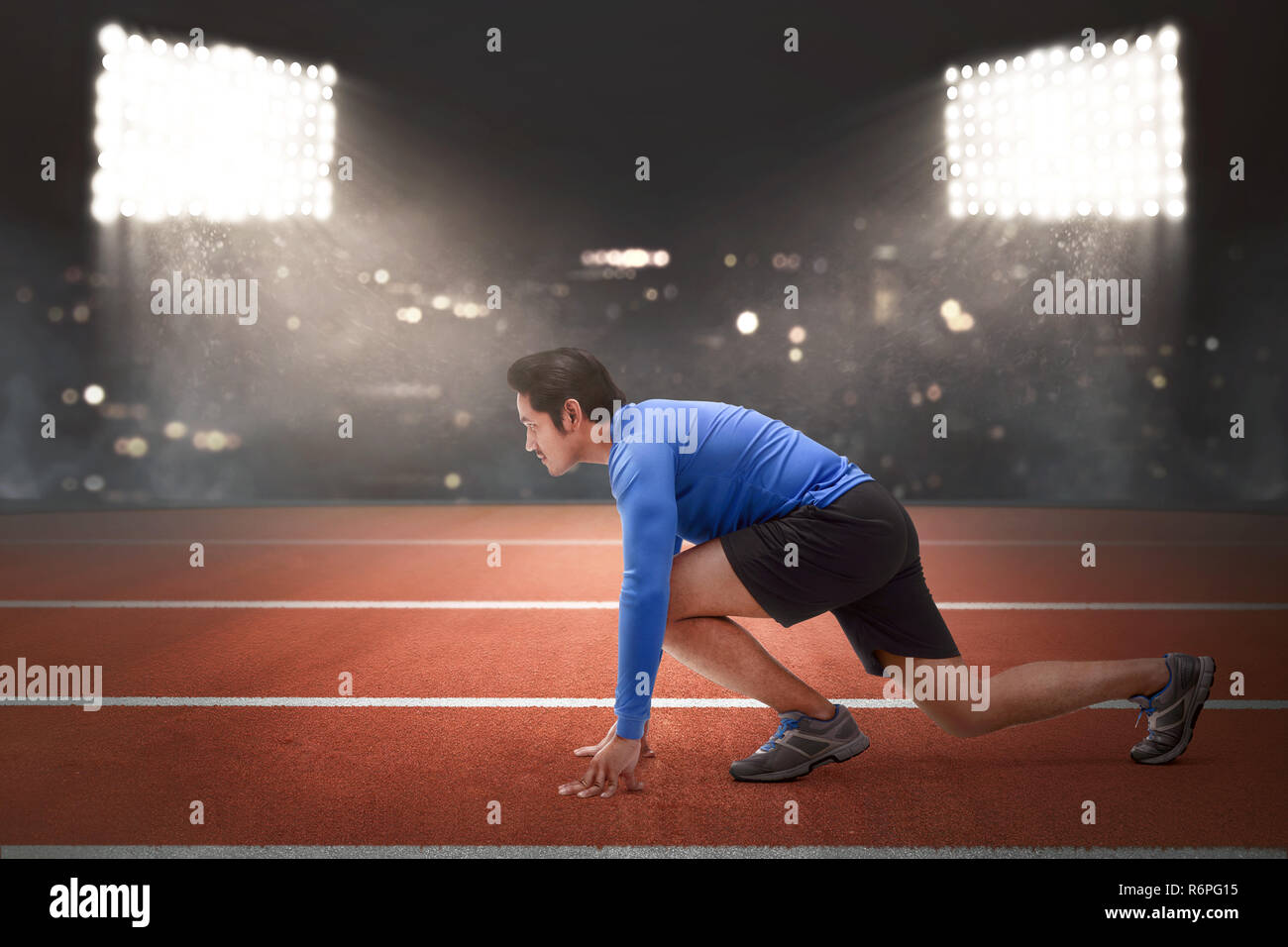 Handsome asian runner man in ready position to run Stock Photo - Alamy