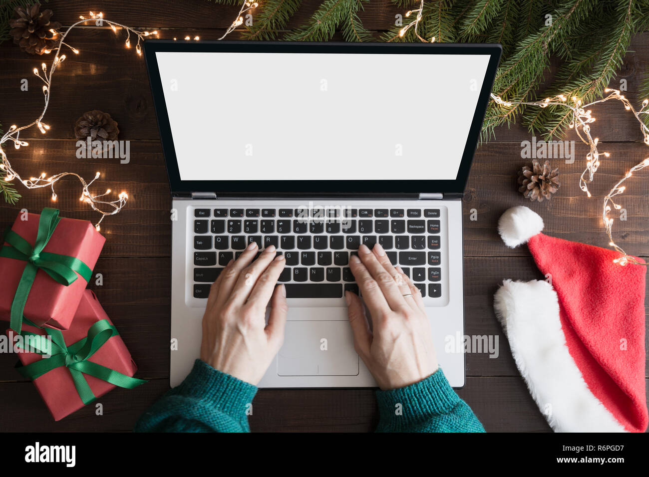 Christmas sales. Woman typing and searching by laptop. Space for text ...