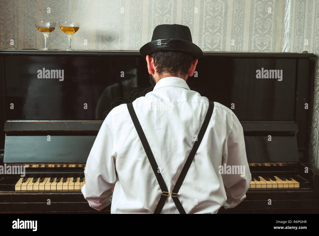 Retro man playing the piano Stock Photo - Alamy